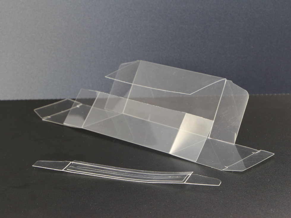 Recycled, transparent folding box with separable seam revealed by ...